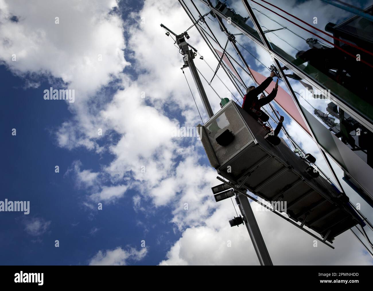 ROTTERDAM - 14/04/2023, Abseilers hang on the 57th floor of the ...
