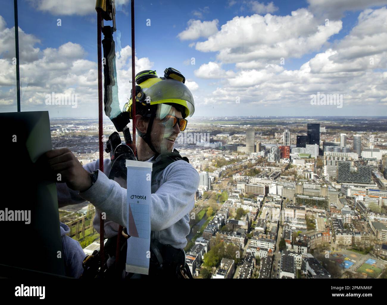 ROTTERDAM - Abseilers hang on the 57th floor of the Rotterdam ...