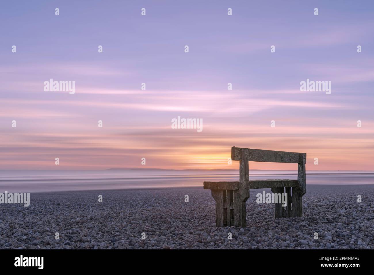 A lone and empty bench on West Wittering beach looking out over the ...