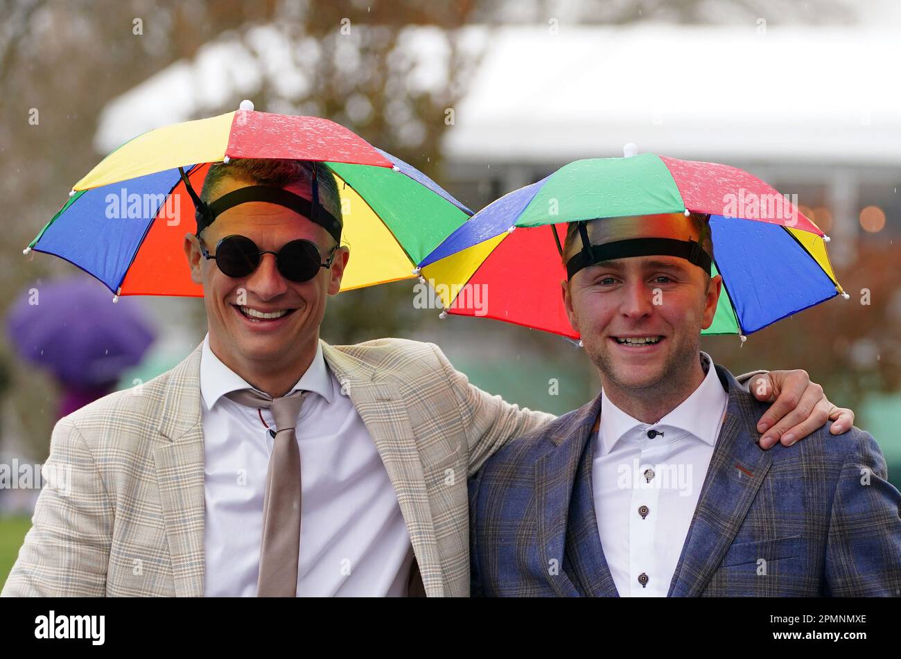Racegoers shelter under umbrella hats ahead of the the Air Charter ...