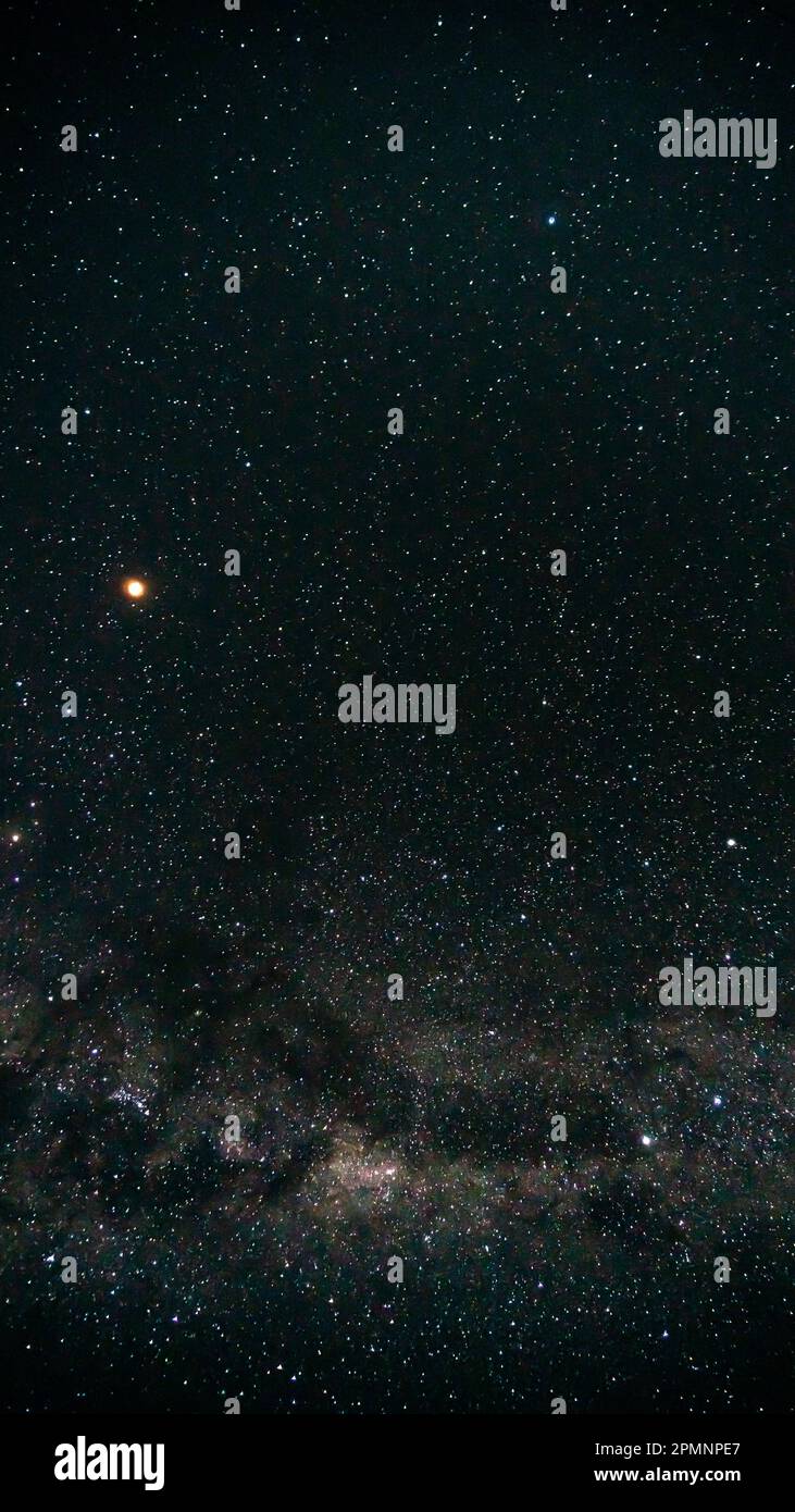 A beautiful nighttime sky with glowing stars and wisps of clouds ...