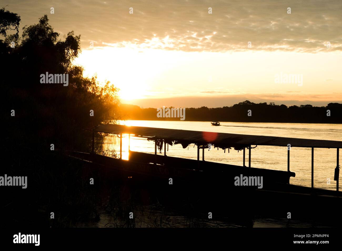 Sunset over Amazon river with boat cloud and forest background at ...