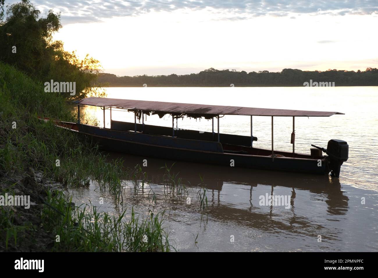 Sunset over Amazon river with boat cloud and forest background at ...