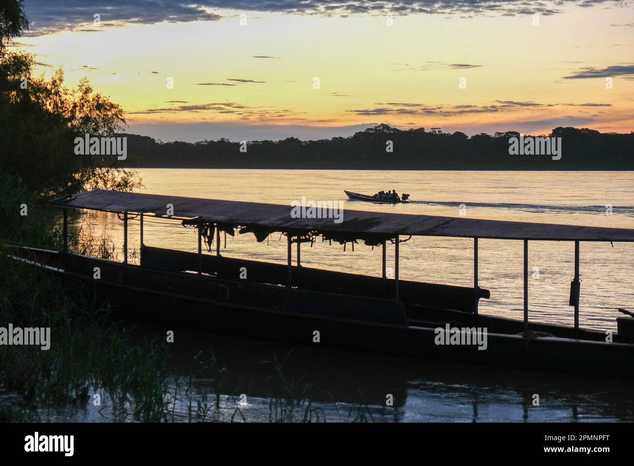 Sunset over Amazon river with boat cloud and forest background at ...