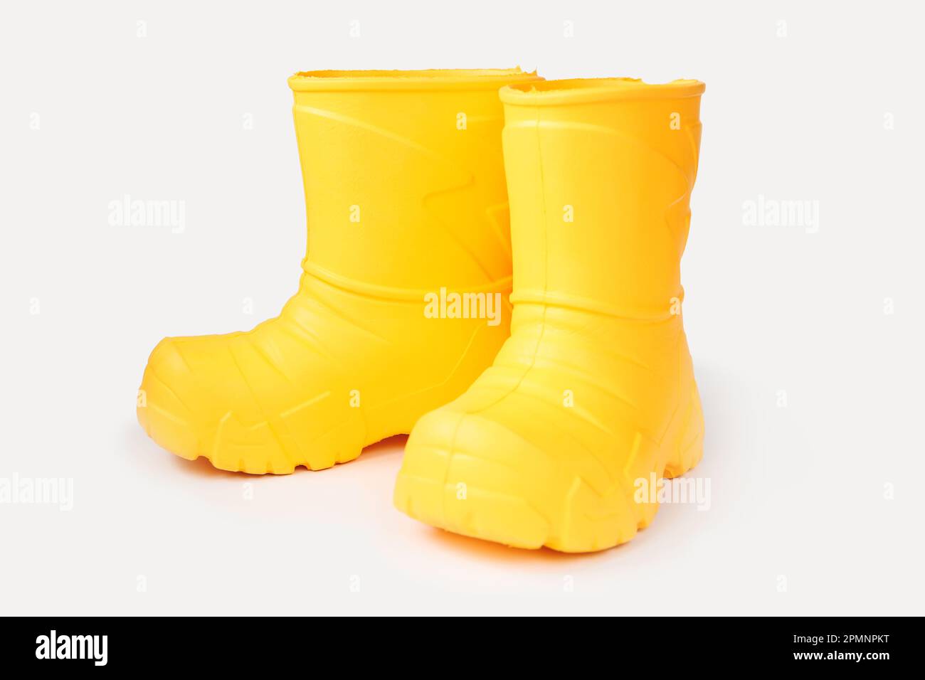 Pair of yellow rubber boots on white background Stock Photo - Alamy