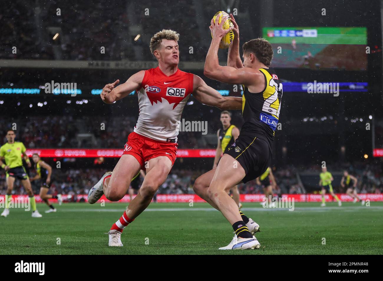 Jacob Hopper of the Tigers is tackled by Chad Warner of the Swans ...