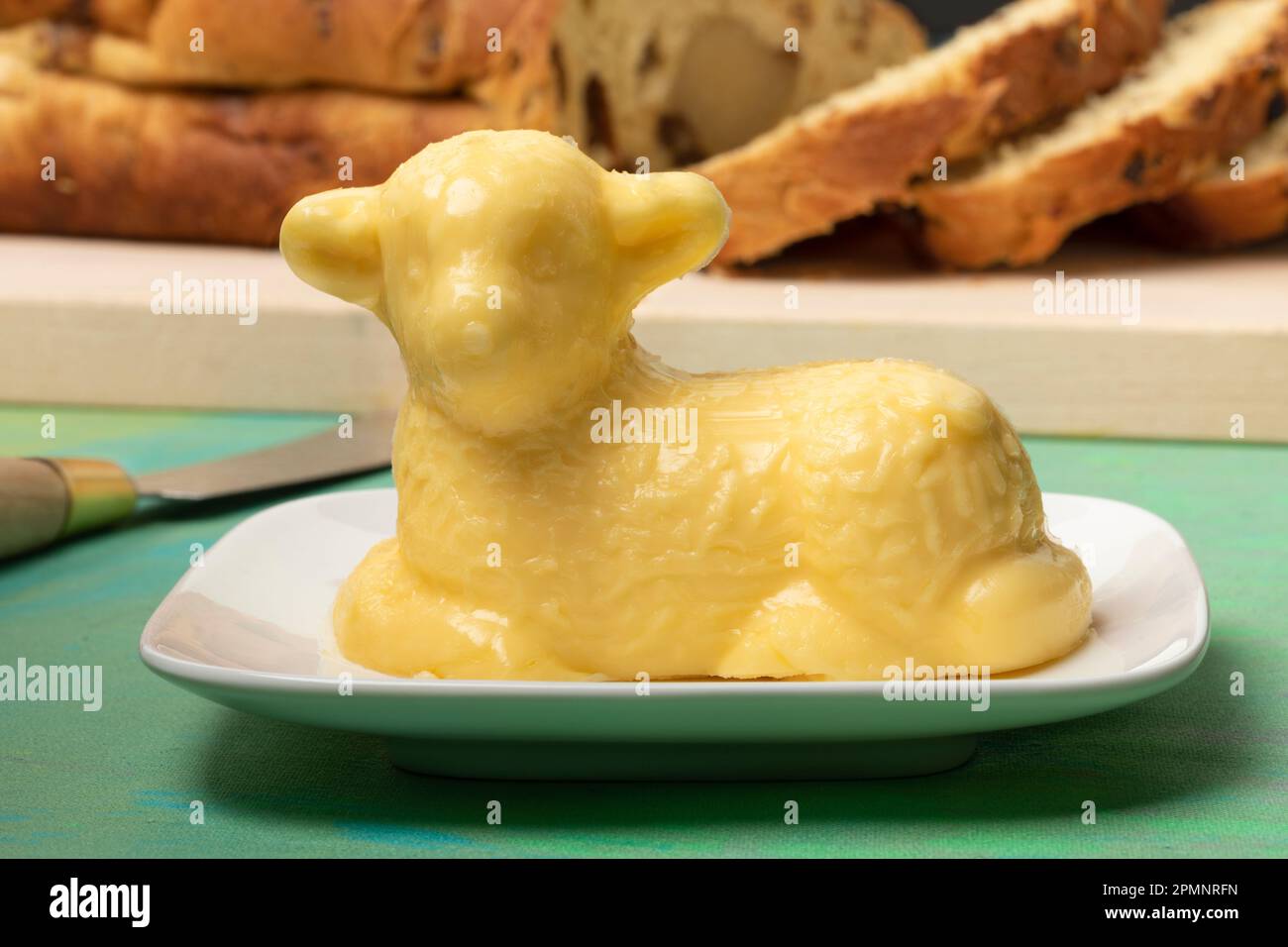 Traditional easter butter lamb in front of slices od an easter bread ...