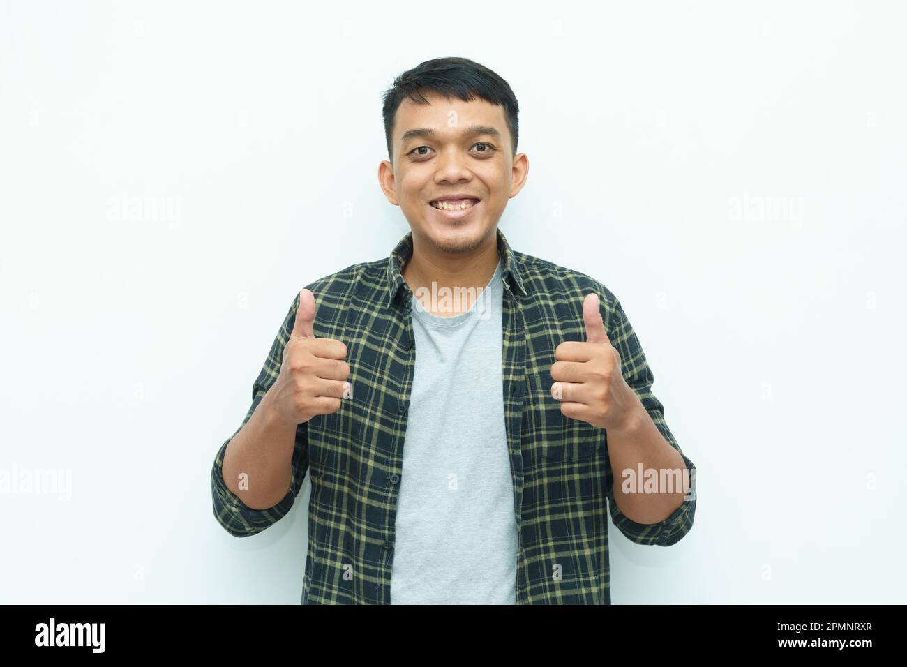 Young Asian man smiling and put the two thumbs up for giving ...