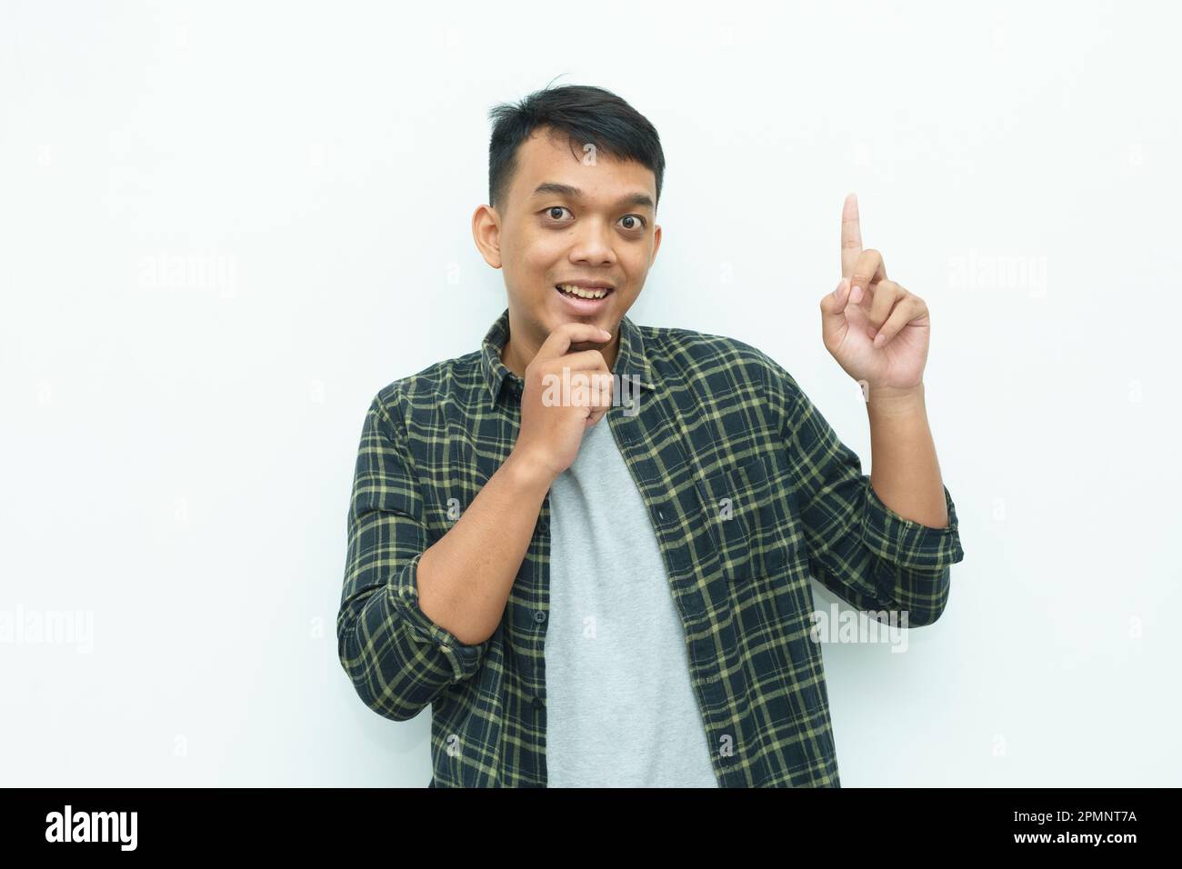 Young Asian man smiling put the hand on the chin and index finger ...