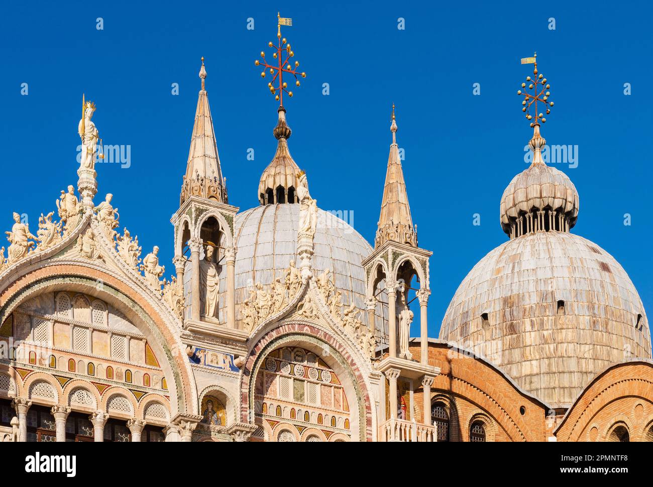 Domes of St Mark's Basilica (Basilica of San Marco) against a blue sky ...