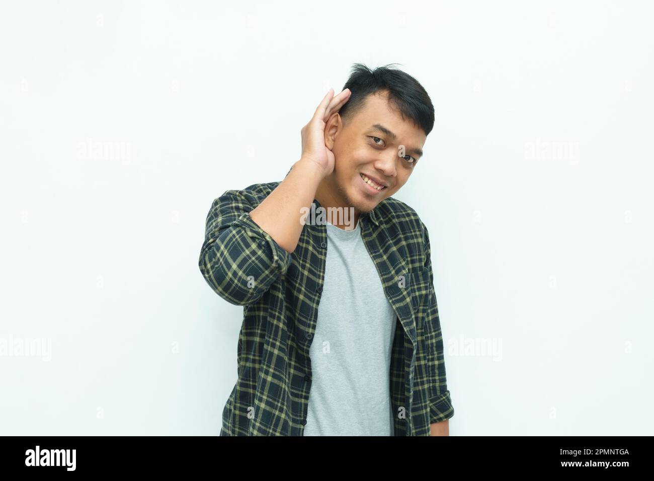 Young Asian man put his hand on the ear as listening gesture and ...