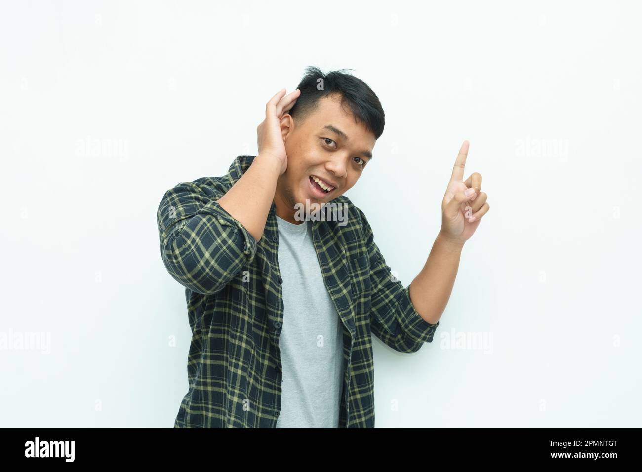 Young Asian man put his hand on the ear as listening gesture and ...