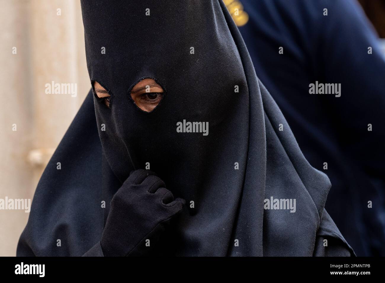 Penitents wearing black pointed hoods process from St. Mary Major ...
