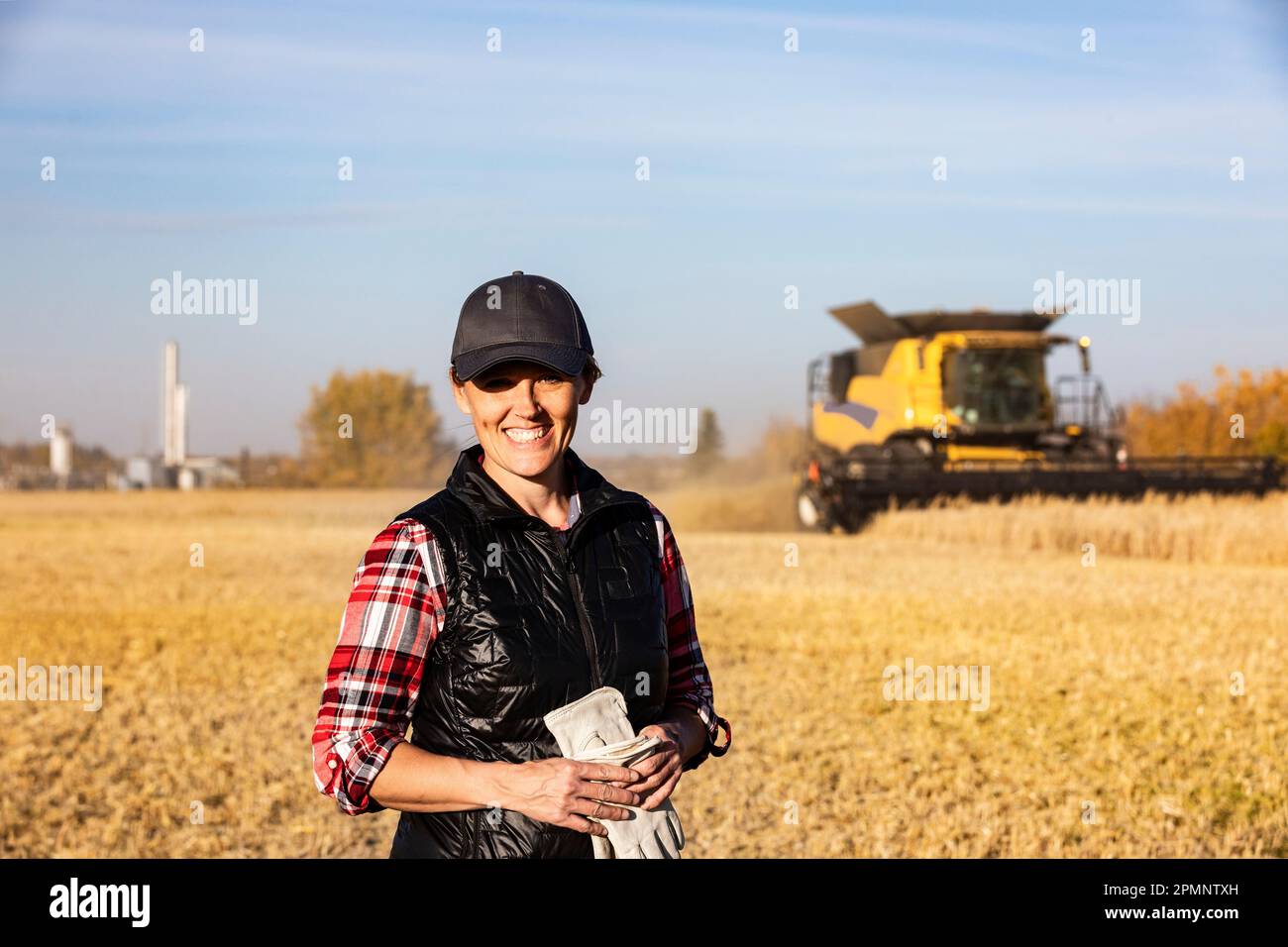 Portrait of a mature farm woman standing in a grain field, posing for ...