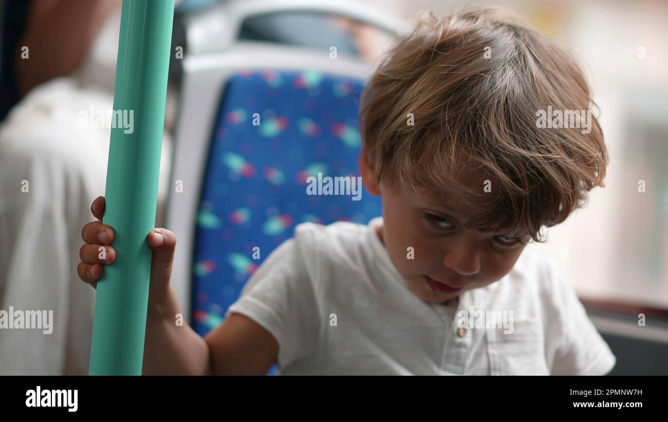Passenger child traveling inside tram transportation holding into metal ...
