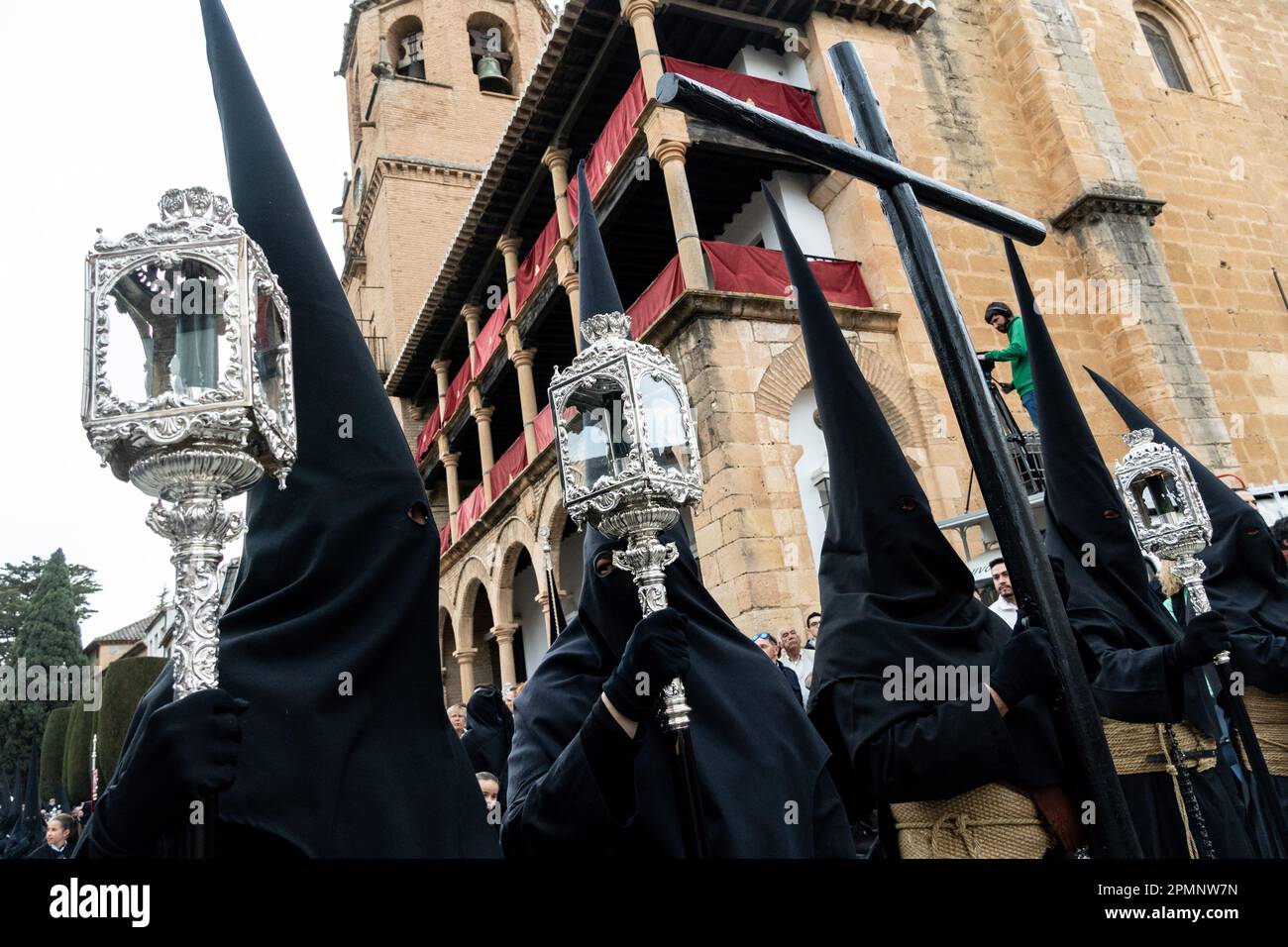 Penitents wearing black pointed hoods process past the St. Mary Major ...