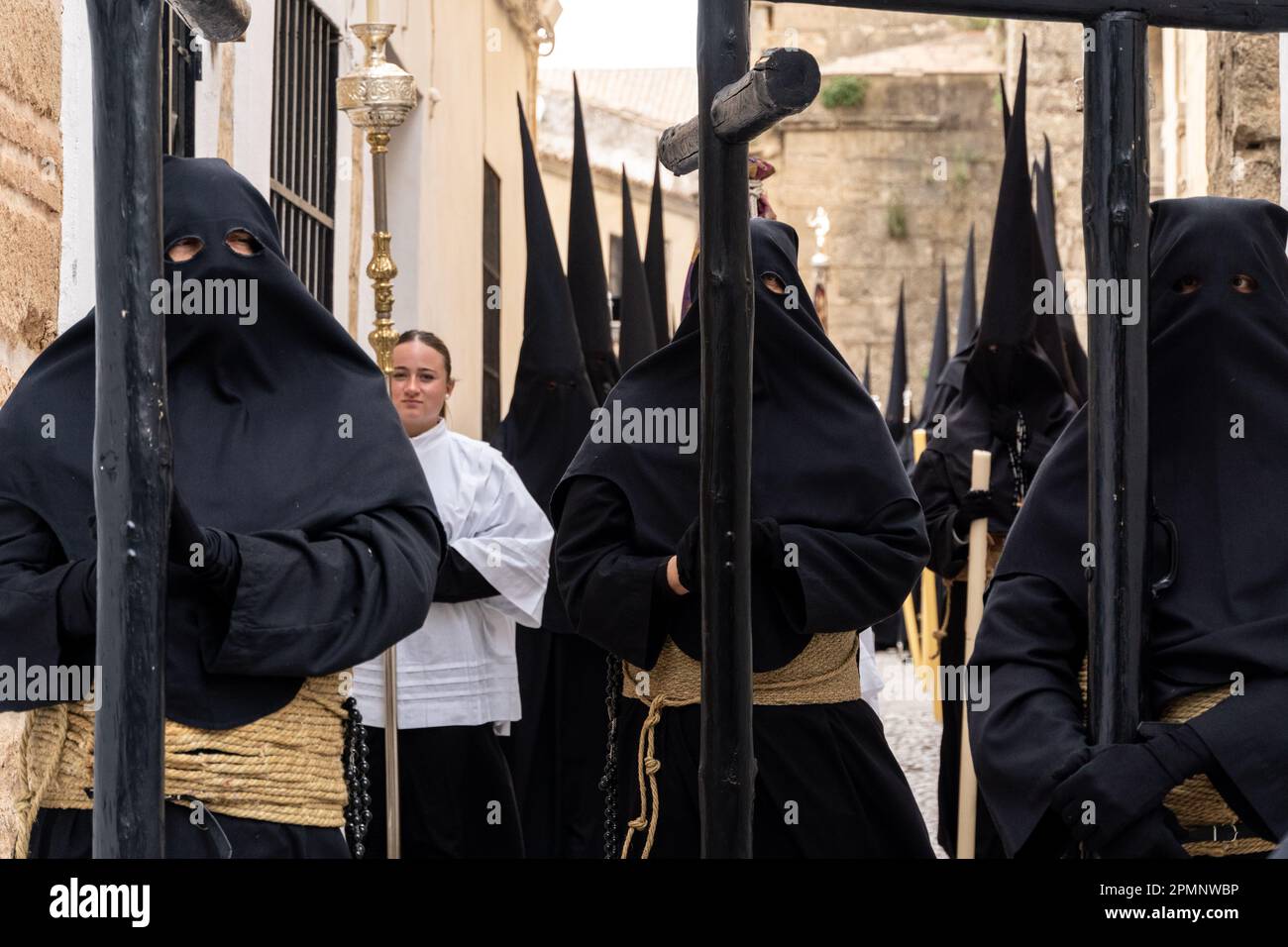 Penitents wearing black hoods carry wooden crosses from the St. Mary ...