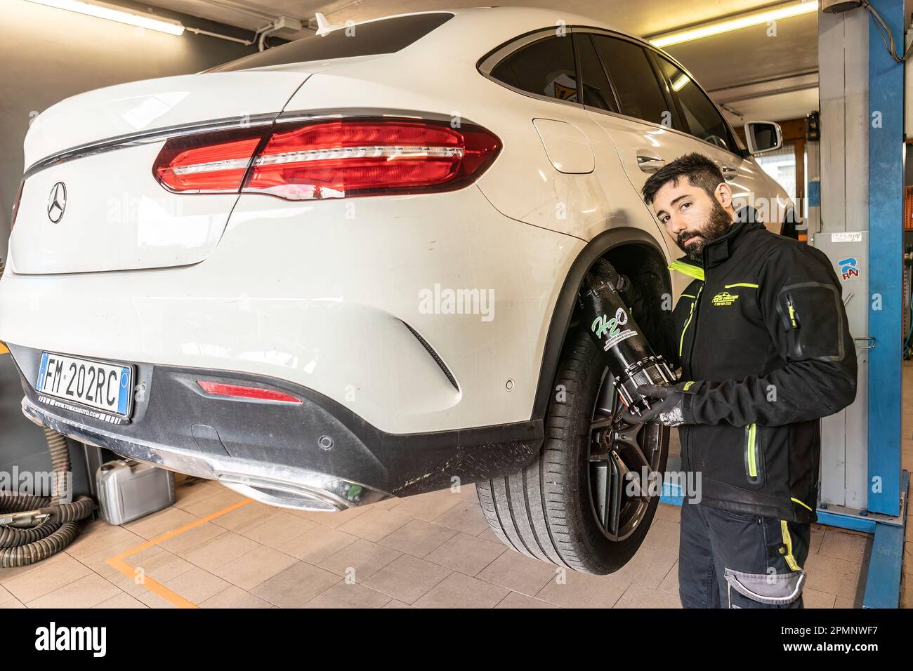 Milan, Italy 11 april 2023: Close-up of a mechanic installing a ...