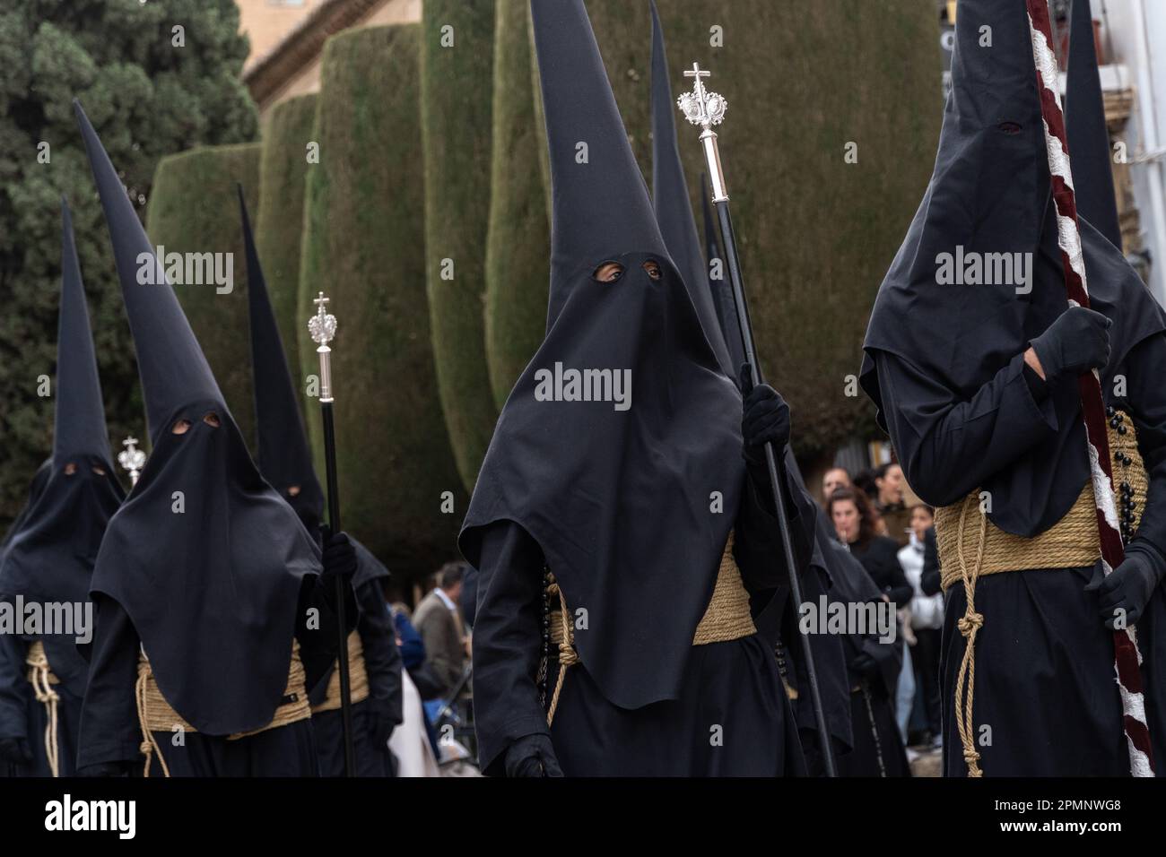 Penitents wearing black pointed hoods process past the St. Mary Major ...
