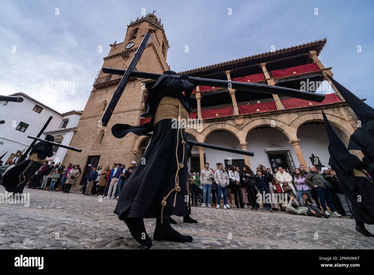 Penitents wearing black pointed hoods process past the St. Mary Major ...