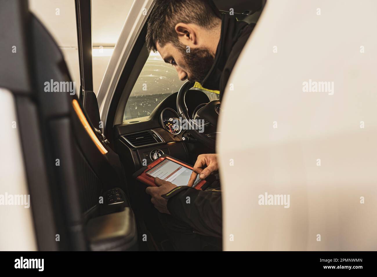 Milan, Italy 11 april 2023: A mechanic's hands use a diagnostic tool to ...