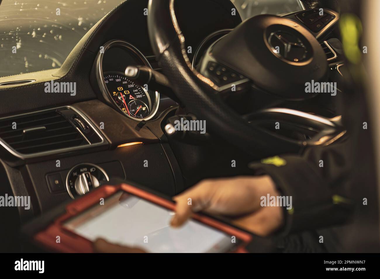 Milan, Italy 11 april 2023: A mechanic's hands use a diagnostic tool to ...