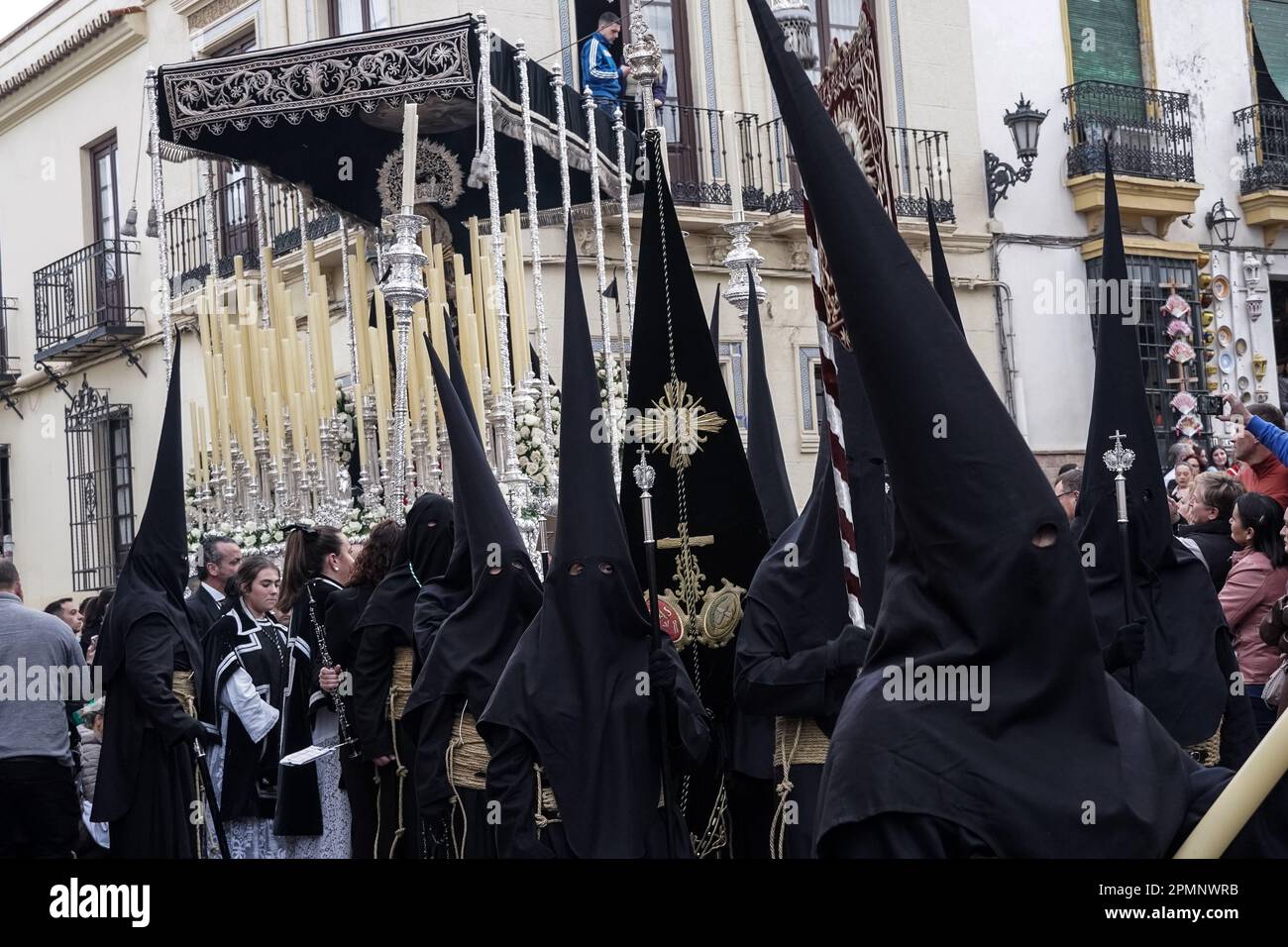 Penitents wearing black pointed hoods process past the St. Mary Major ...