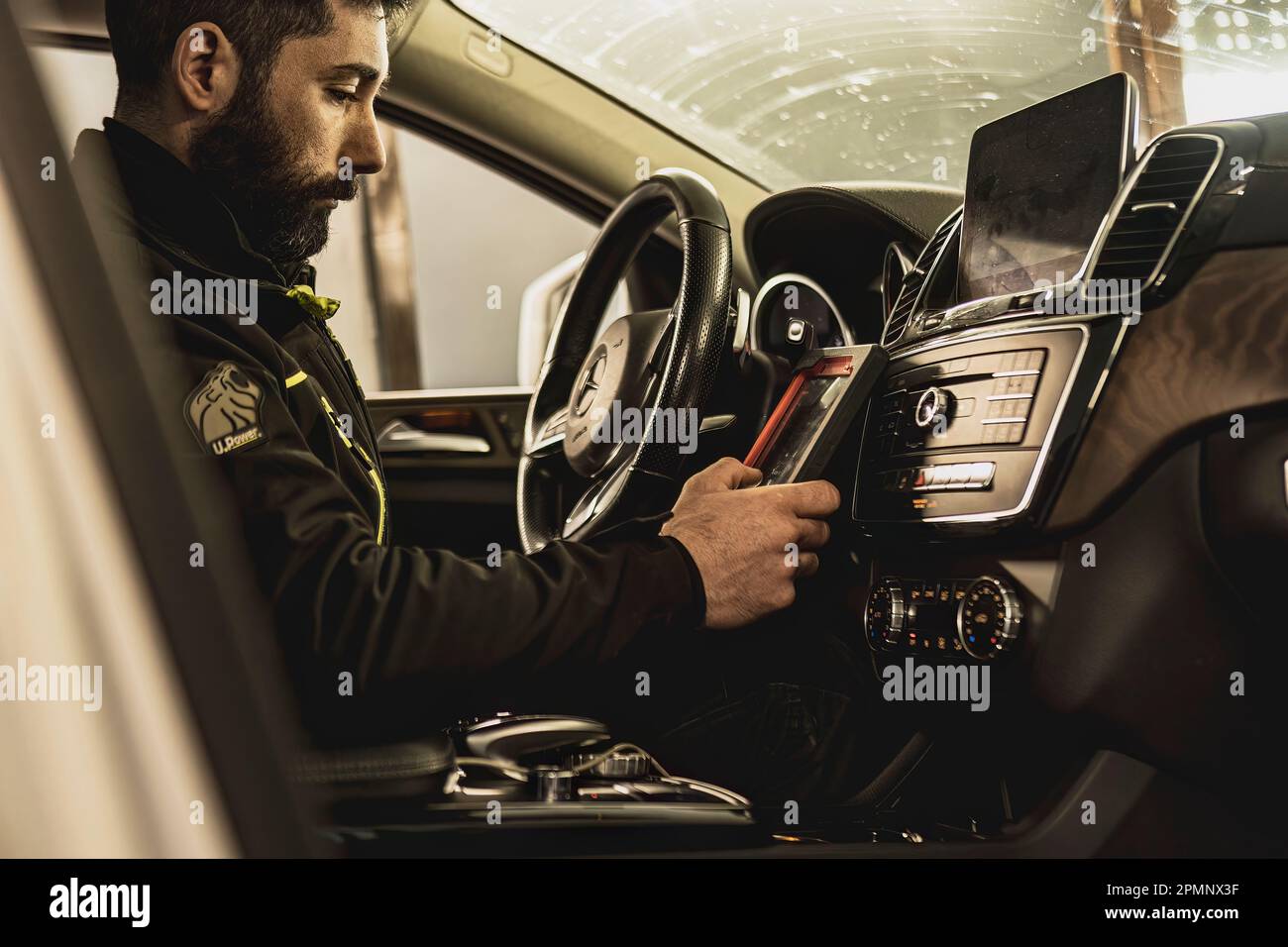 Milan, Italy 11 april 2023: A mechanic's hands use a diagnostic tool to ...