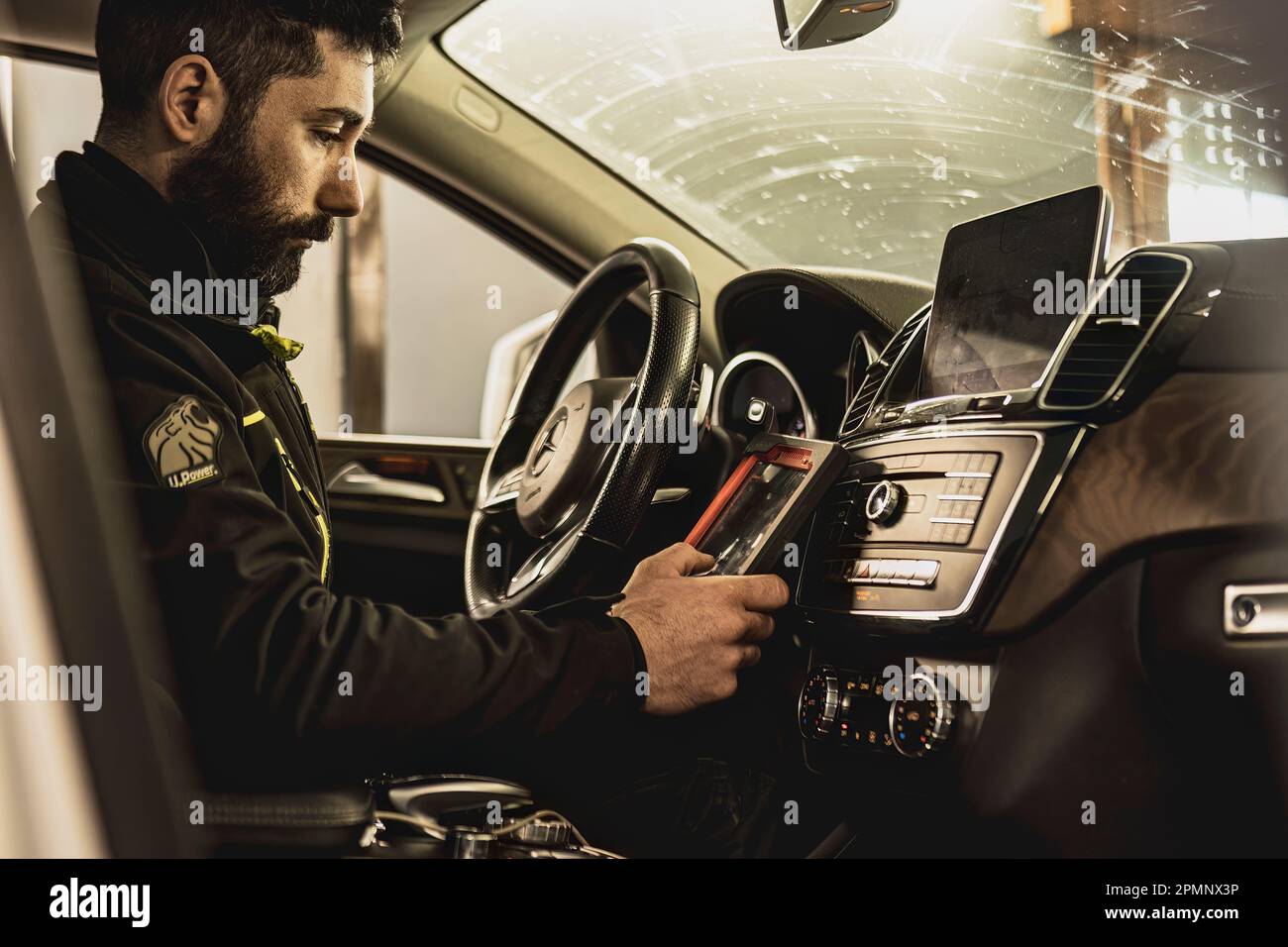 Milan, Italy 11 april 2023: A mechanic's hands use a diagnostic tool to ...