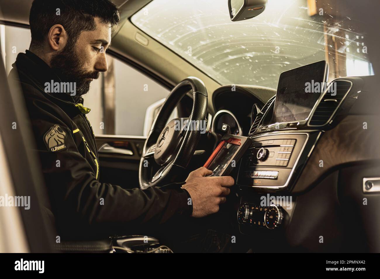 Milan, Italy 11 april 2023: A mechanic's hands use a diagnostic tool to ...