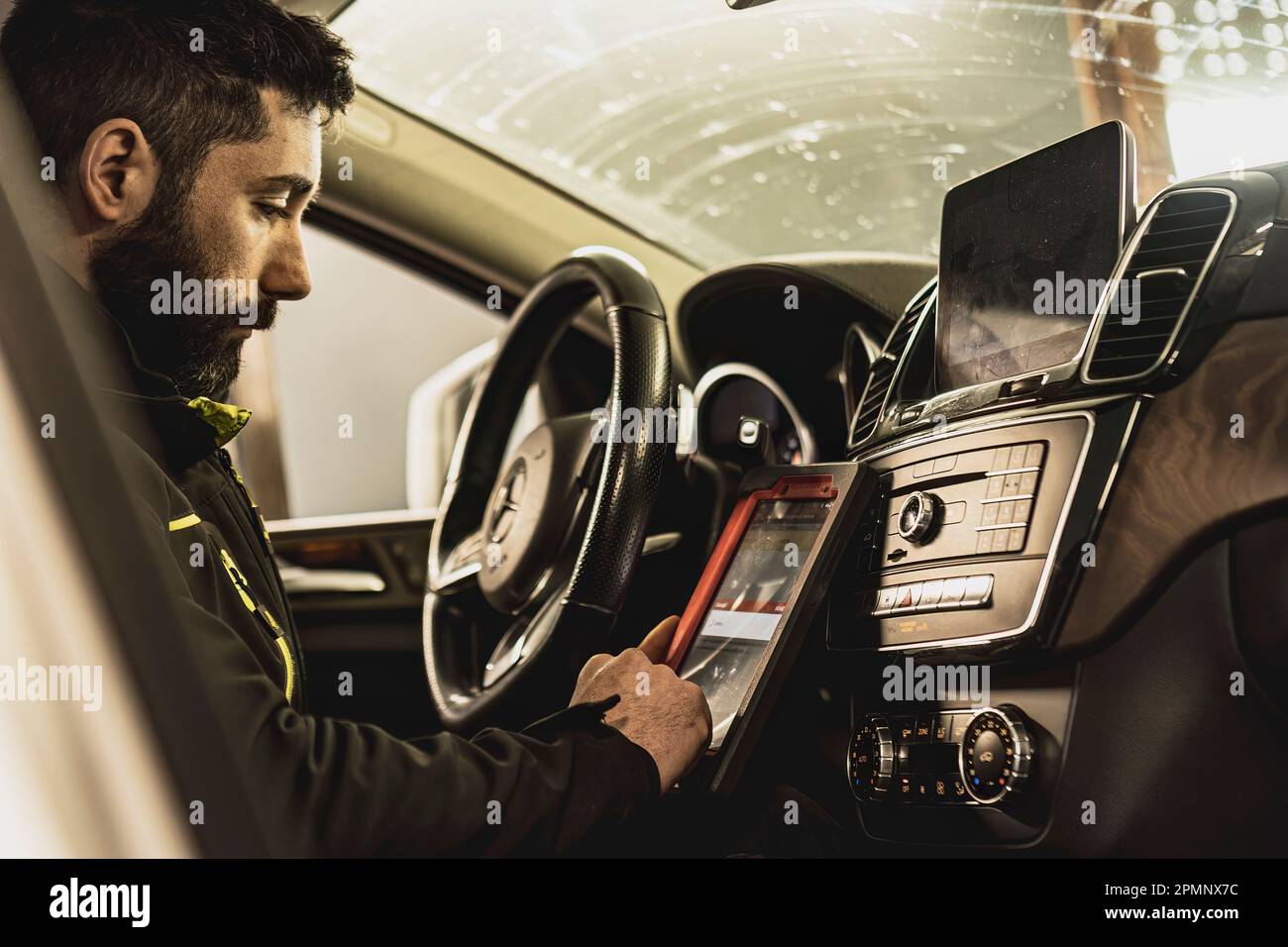 Milan, Italy 11 april 2023: A mechanic's hands use a diagnostic tool to ...
