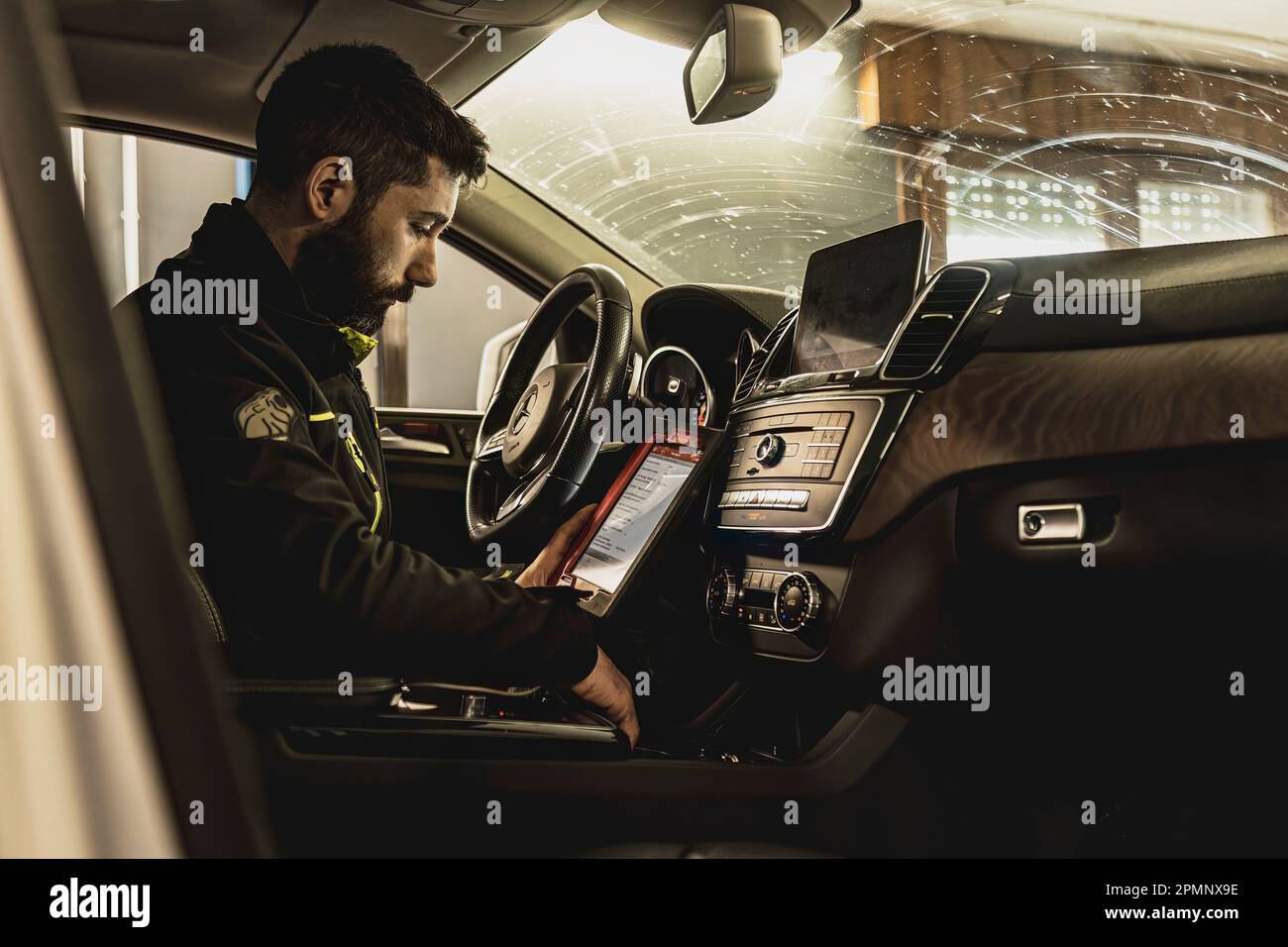 Milan, Italy 11 april 2023: A mechanic's hands use a diagnostic tool to ...