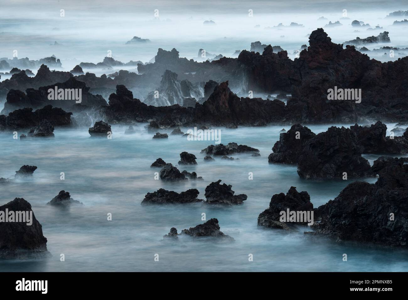 Long exposure of surf pouring over lava rocks at Easter Island; Easter ...
