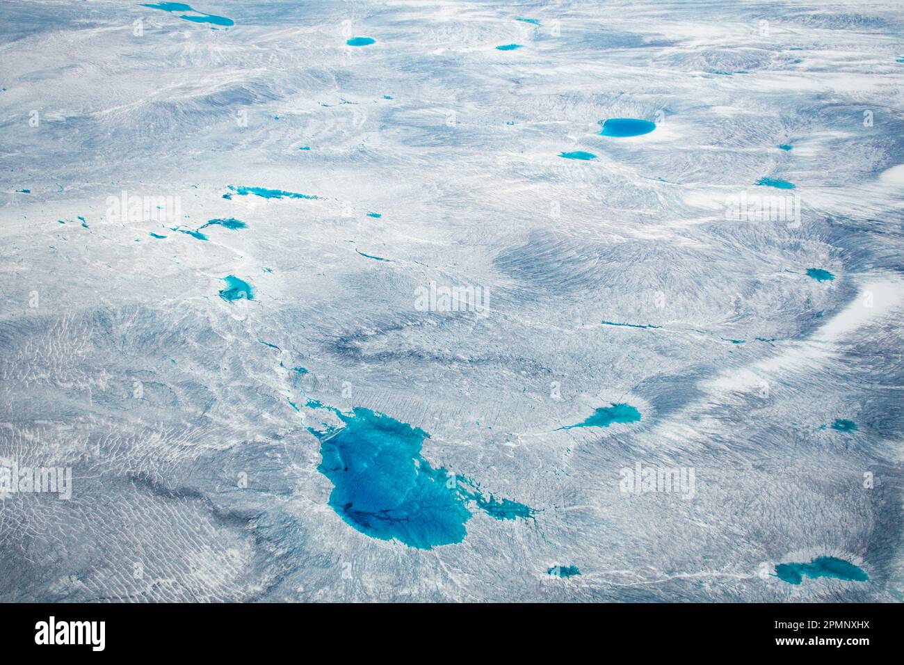 Aerial view of Greenland ice sheet and blue lakes; Ilulissat, Greenland ...
