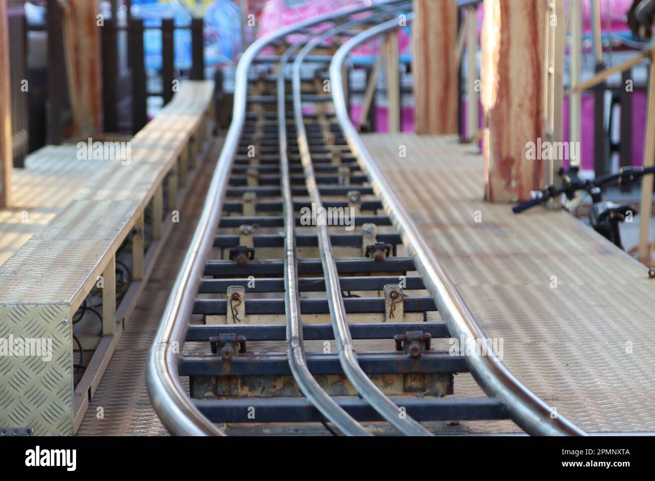 An array of colorful toy train tracks featuring curved sections and multiple accompanying ...