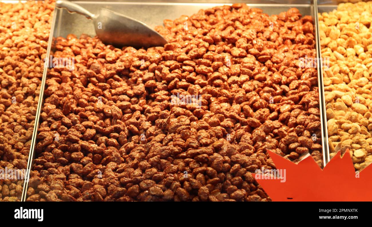 A colorful assortment of edible nuts is showcased in a vibrant market ...