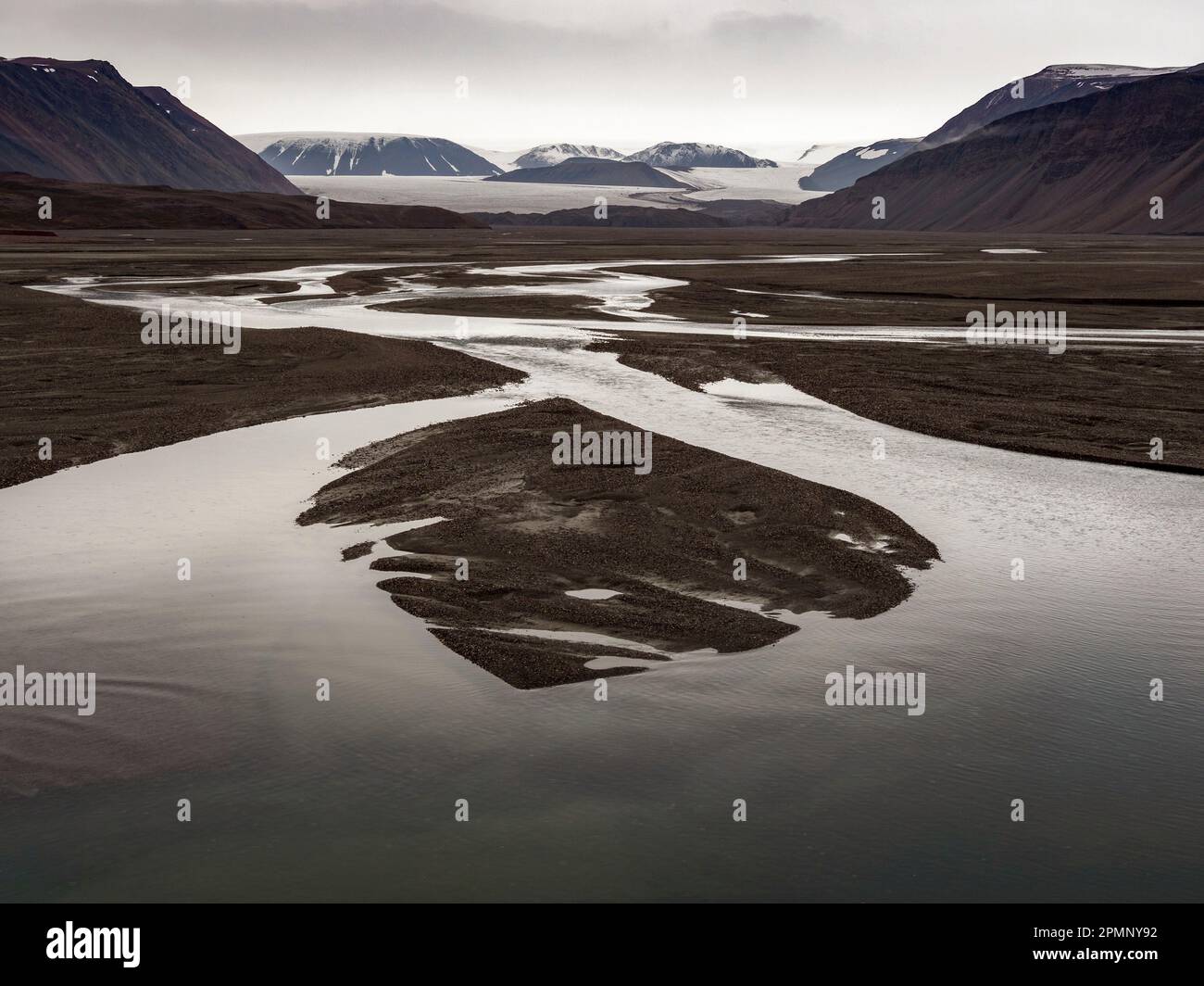 Braided river flows down from the glacier; Spitsbergen, Svalbard ...