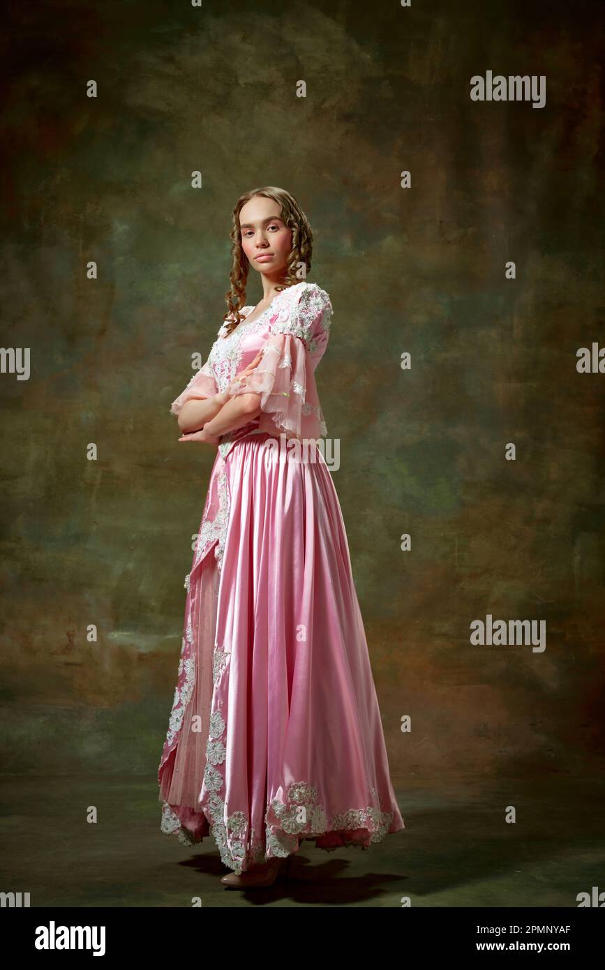 Portrait of charming blond girl, princess wearing fancy pink dress and ...