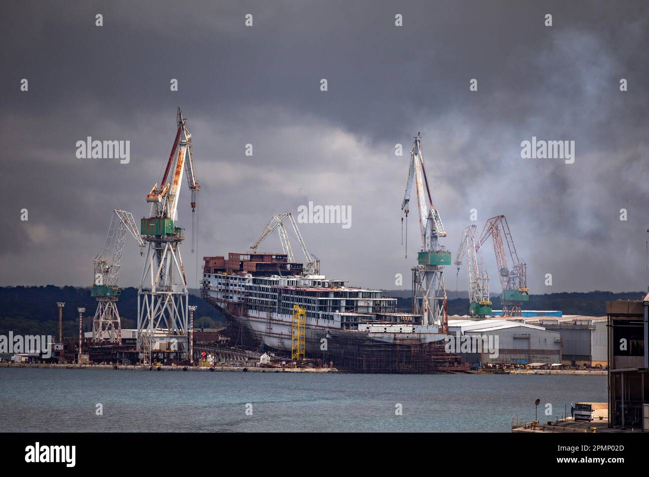 The sky covered with dark rain clouds over the city of Pula, Croatia on ...