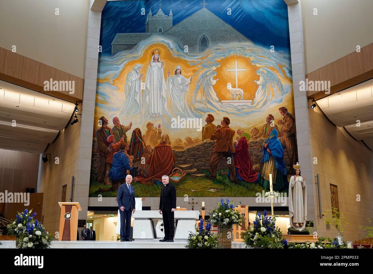 President Joe Biden stands with Father Richard Gibbons, parish priest ...
