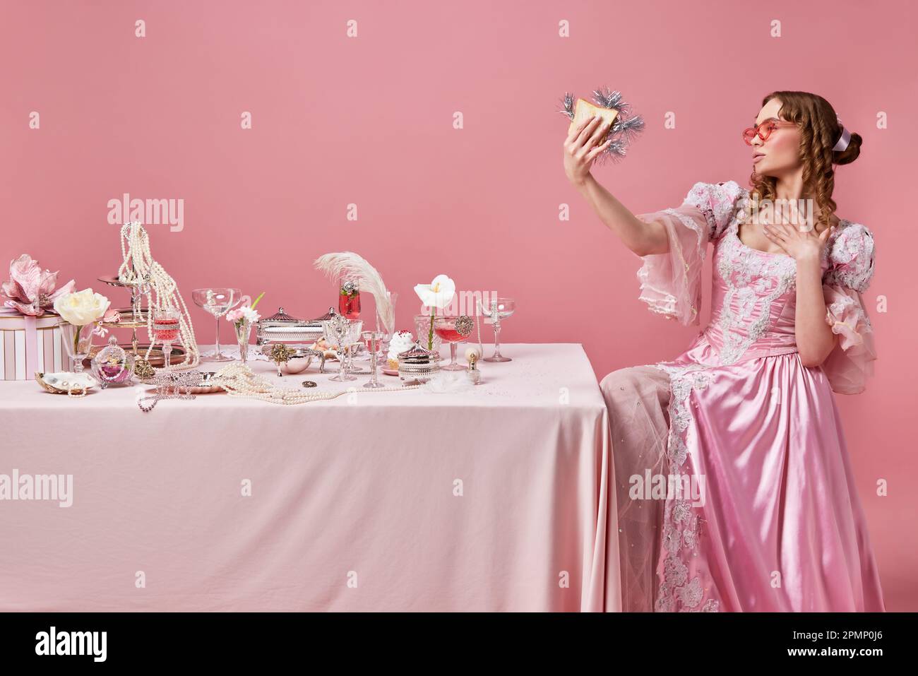 One hungry princess wearing baroque dress holding sandwich and looking ...