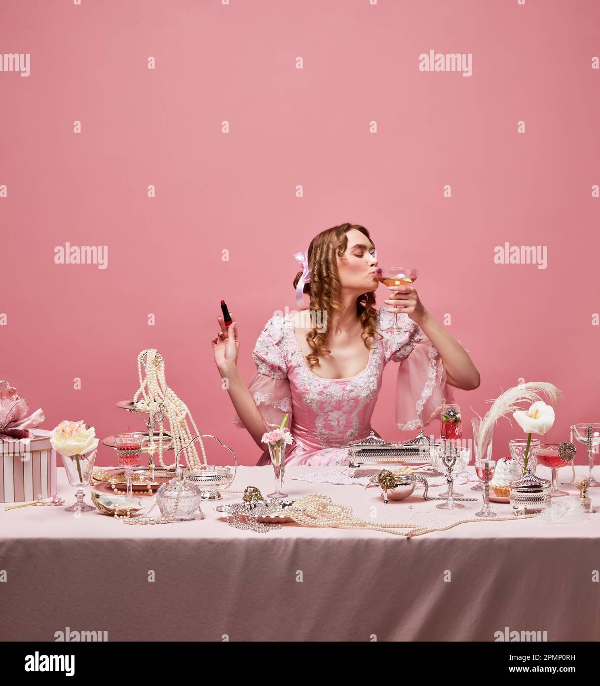 Shot of adorable blond princess wearing fancy pink dress and sitting at ...