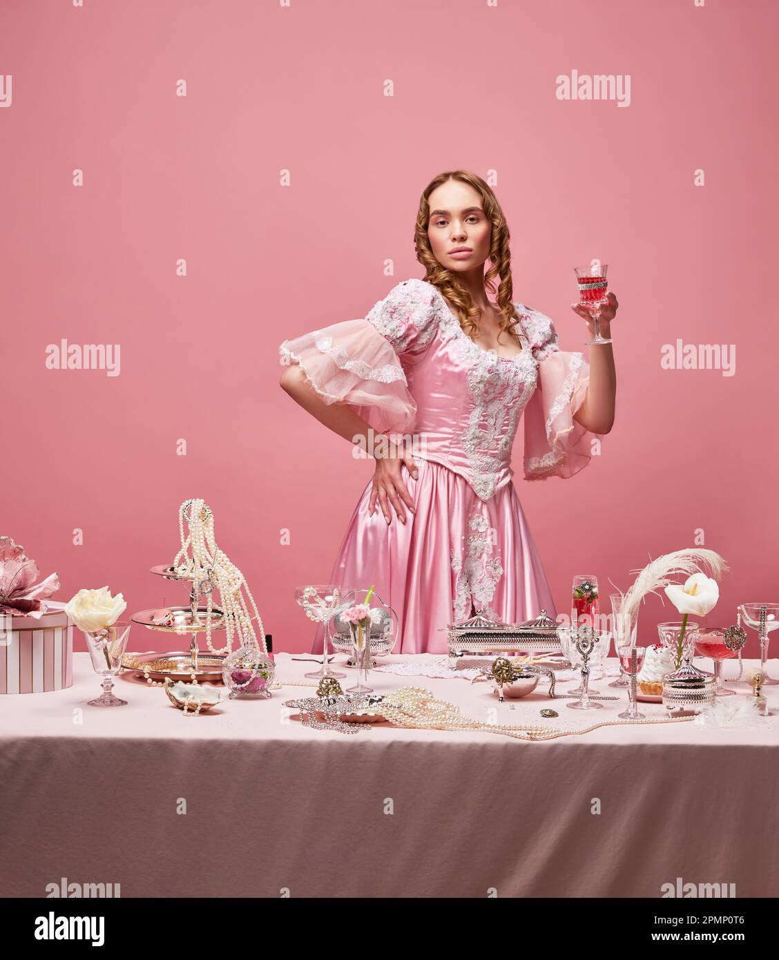 Shot of beautiful woman, princess wearing renaissance pink dress and ...