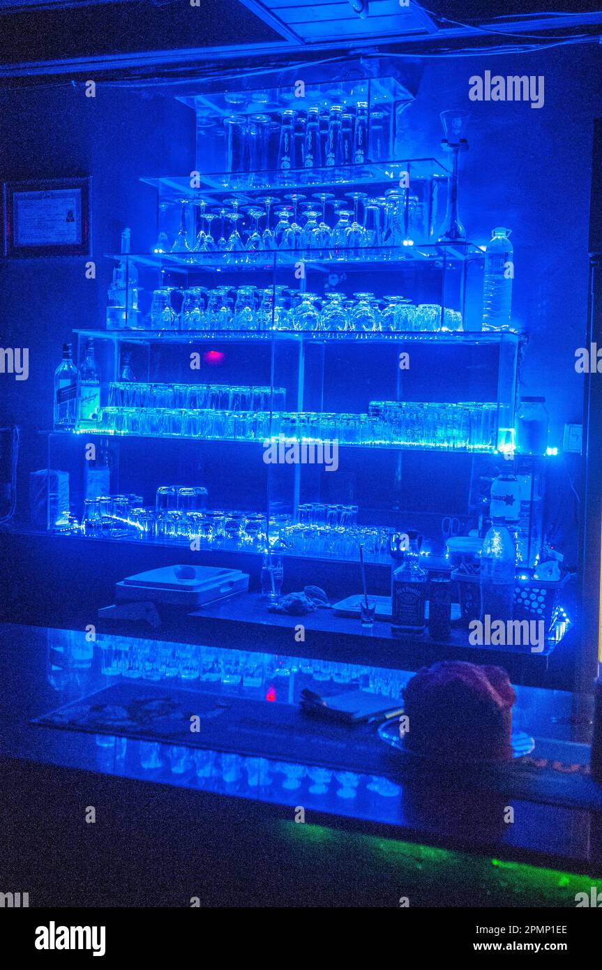 Glowing wall of glasses & alcohol at a bar, Phnom Penh, Cambodia ...