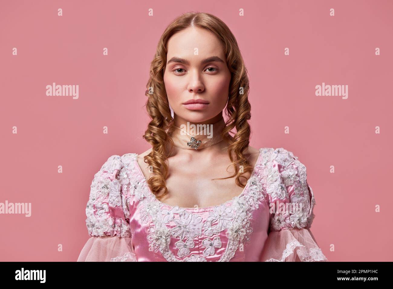 Shot of beautiful princess wearing baroque pink dress and posing over ...