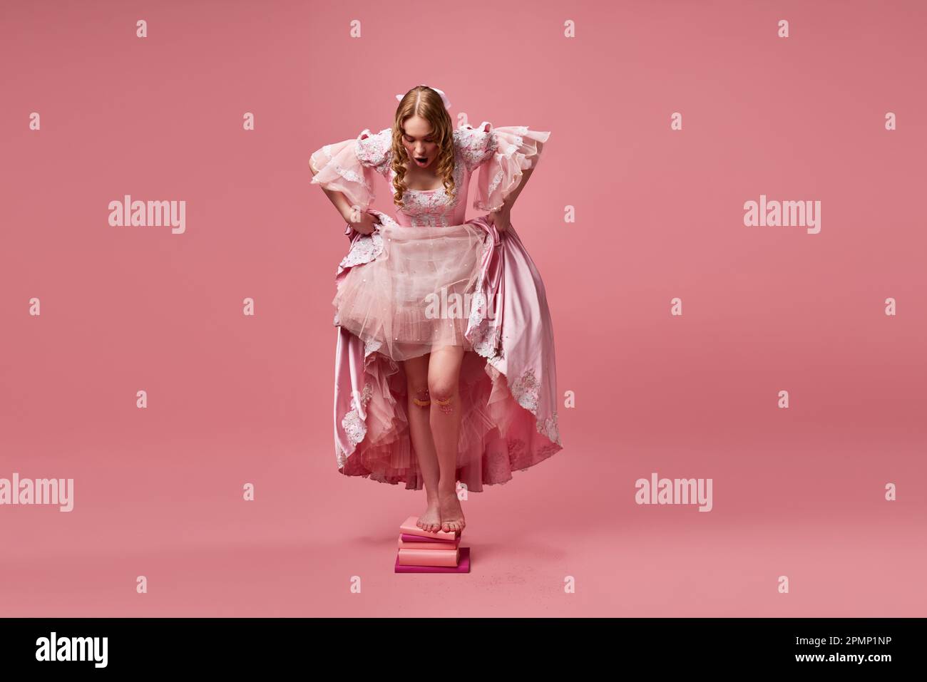 Shot of beautiful princess wearing vintage pink dress and standing on ...