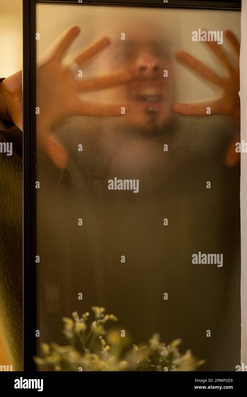 Men's portrait through a matte glass Stock Photo - Alamy