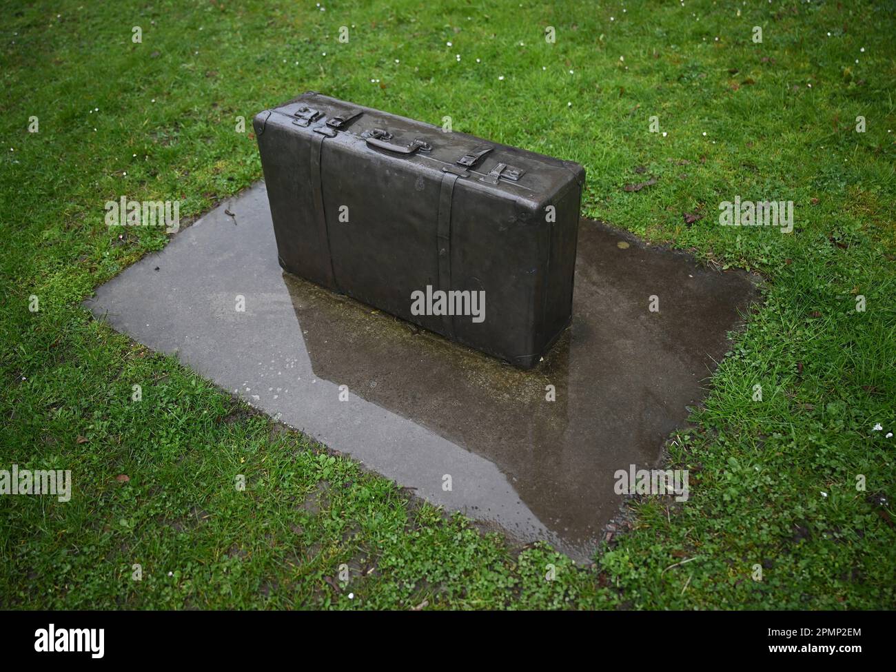 Berlin, Germany. 14th Apr, 2023. Bronze cast of a refugee suitcase ...