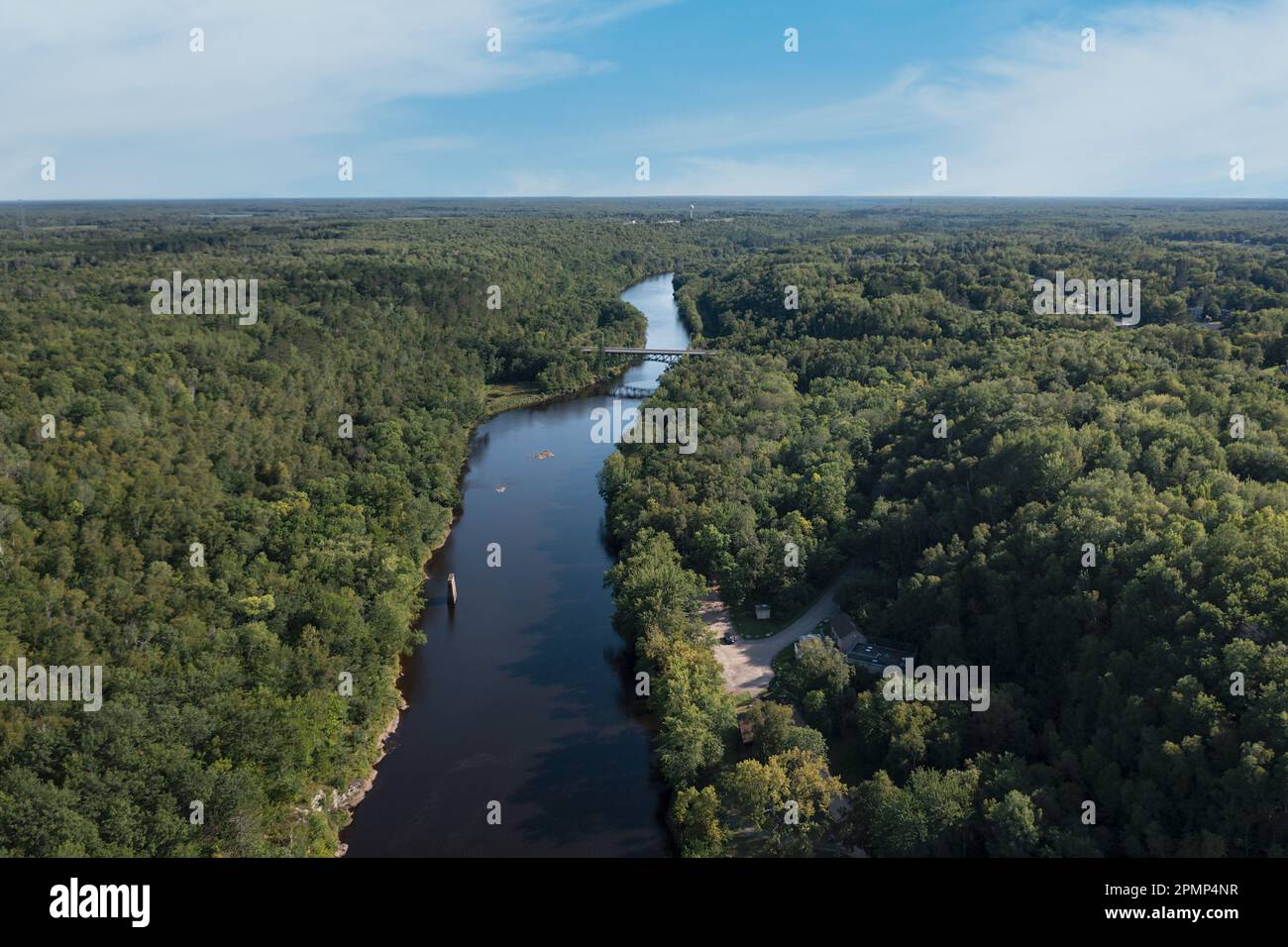 River With Trestle Bridge Passes Through Forests - drone aerial Stock ...