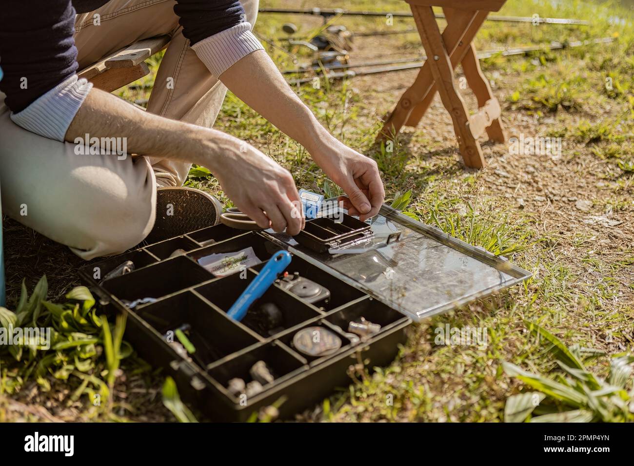 A photo of a fisherman getting ready to catch carp, preparing bait on ...